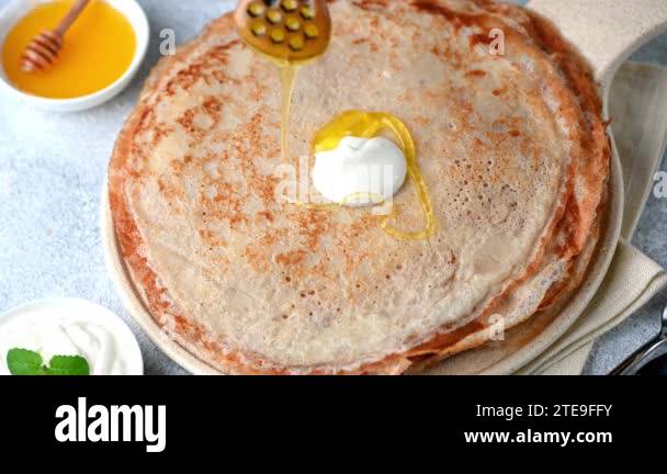 Pancakes with maple syrup. Pouring syrup on pancakes. Pouring honey on ...