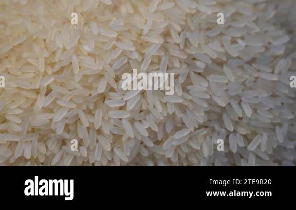 Full frame background of raw white rice rotating on turn table. View ...