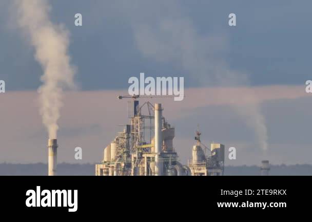 Timelapse of cement plant with high factory structure and tower cranes ...