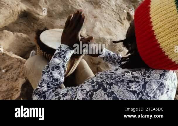 African percussion music, a Senegalese man plays a traditional djembe ...