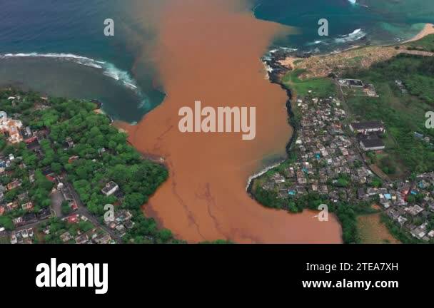 Floods in the streams, wide dirty river with muddy orange water and ...