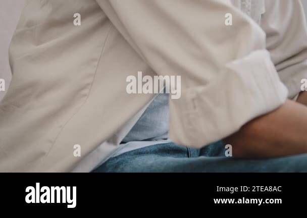 Close-up of male hands holding belly by side unrecognizable man feels ...