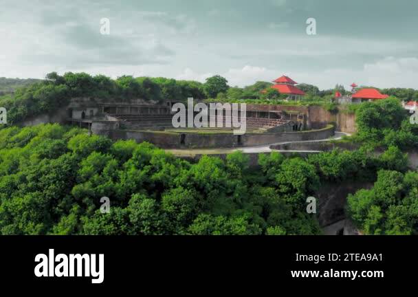 A huge amphitheatre for performances surrounded by green tropical trees ...