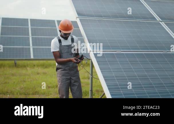 African american controlling production of green energy on station. Man ...