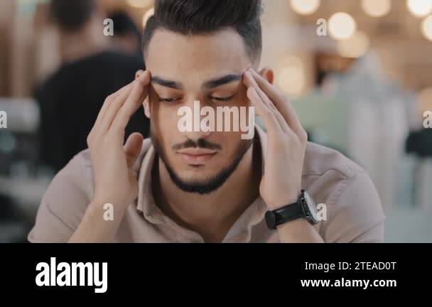 Close-up young unhealthy sad guy massaging temples suffering from ...