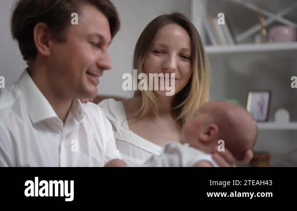 Rack focus from happy Caucasian mother putting head on husband shoulder ...