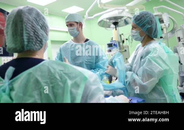 team of highly professional surgeons and nurses is operating patient in ...