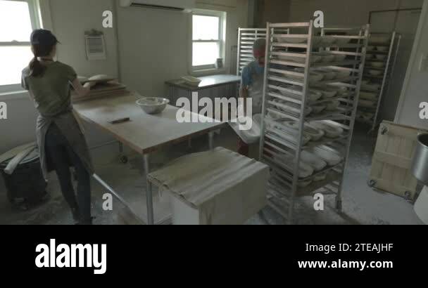 Bakers make bread in a craft bakery, working with whole wheat dough to ...