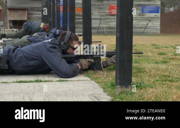 Police officer shoots an assault rifle during target practice at a gun ...
