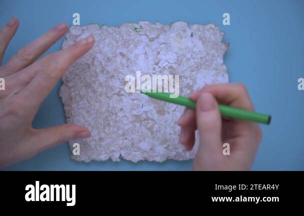 Womens hands draw a sign of reuse with a green felt-tip pen. Drawing on ...