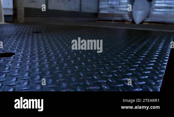 Metal loading ramp at the back of a freight trailer on a loading dock ...