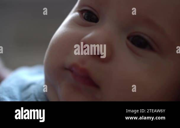 Close-up Cute Face Of Newborn Baby In Early Days Wakes Up And Opens ...