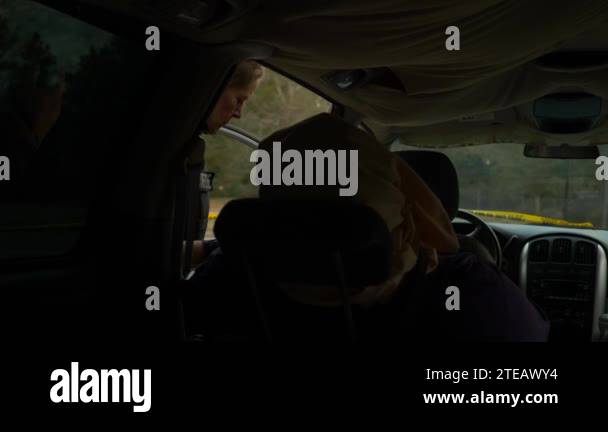 A crime scene investigator at the scene of a crime to inspect details ...