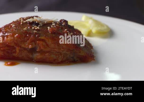 Fish boiled in spiced gochujang sauce. Braised plaice using spicy sauce ...