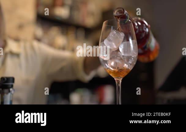 Preparing an Aperol Spritz Cocktail. Close up bartenders hands pouring ...