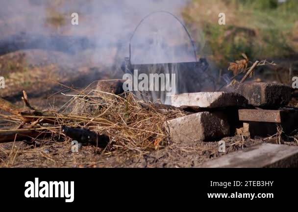 Cooking Food in a Saucepan Over an Open Bonfire in Smoke at Sunset ...
