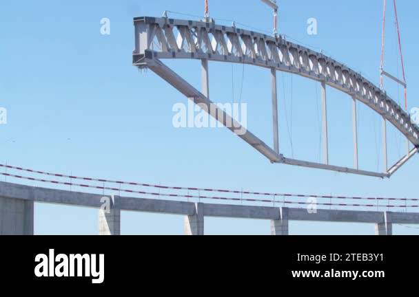 Large roof carcass part hangs on cranes jibs ready to install on ...