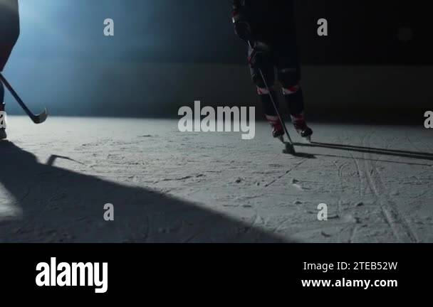 Two men hockey player masterfully dribbles, hitting puck with stick and ...