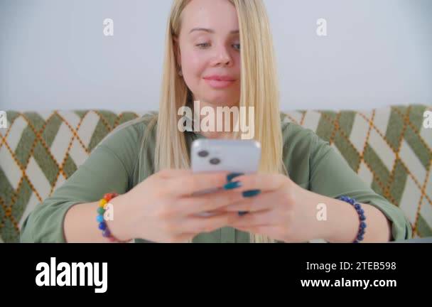 Beautiful blonde white woman with one eye and scars using mobile phone ...