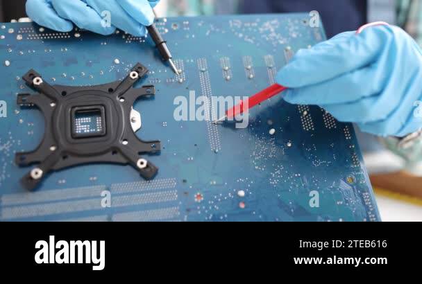 Repairman diagnosing breakdown in computer motherboard using tester ...