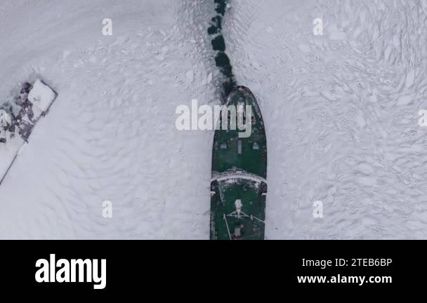 A huge icebreaker breaks the ice with the bow of the ship and floats in ...