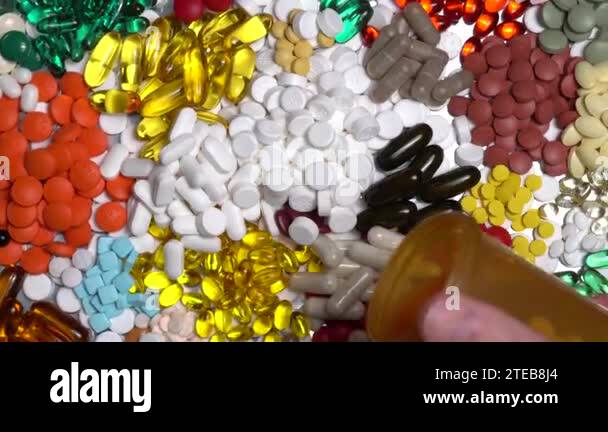 Man drop prescription pills from a bottle in plate with drugs. The pain ...