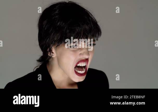 Shouting mouth, screaming face. Angry frustrated female face looking ...