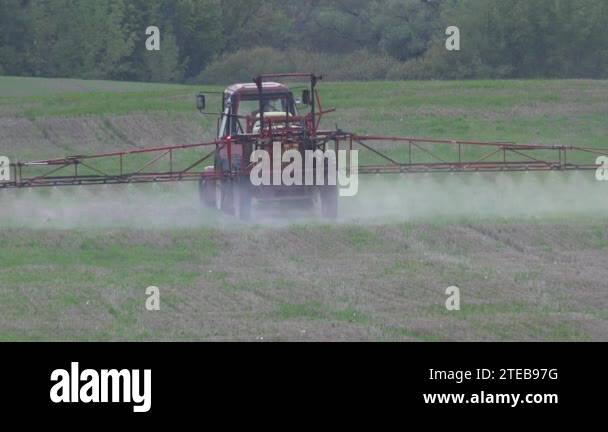 Back of vehicle spread fertilizer herbicide on farm field of wheat ...