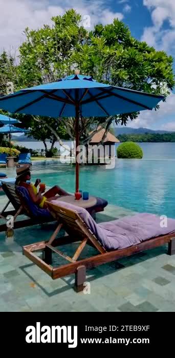 cocktails on an edge of an infinity pool of a luxury hotel. colorful ...