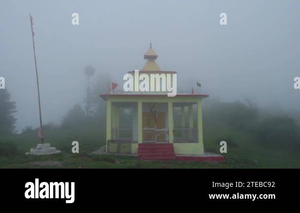 A small hindu temple surround with dense fog on a hill top in northern ...