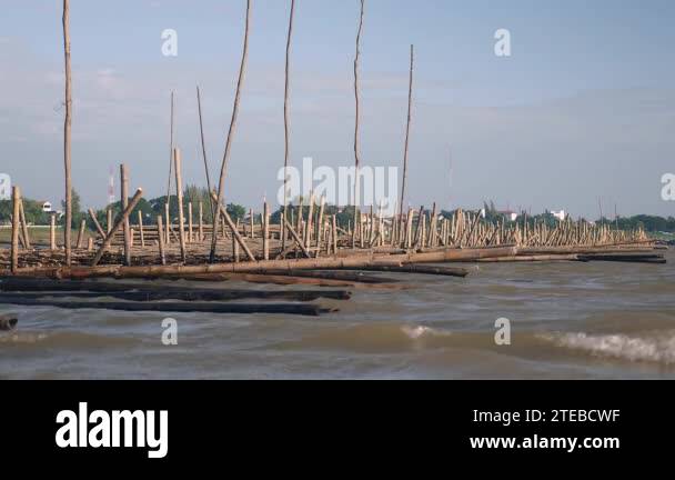 Water-level side view of a bamboo bridge built across a river (the wind ...