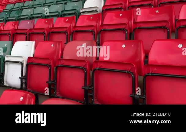 Empty stadium with red green and which spectator seats in the sports ...