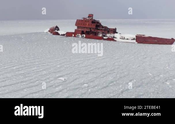 A cargo ship was thrown ashore during a sea storm. In winter, a large ...
