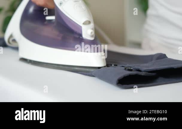 The process of ironing and steaming the shirt. Care of clothes Stock ...