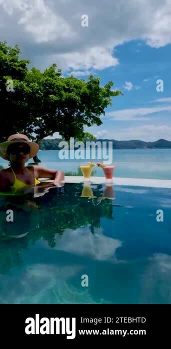 cocktails on an edge of an infinity pool of a luxury hotel. colorful ...