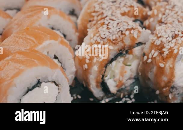Sushi rolls rotating close-up. Fresh Japanese sushi with Philadelphia ...