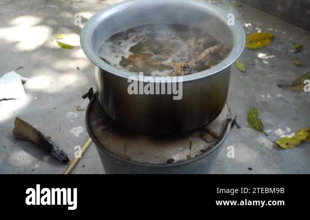 A close up shot of turmeric root being boiled in a big pot . Turmeric ...