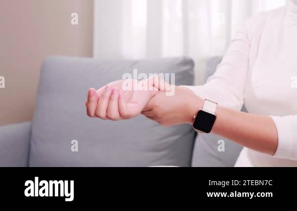 Detail of female hands performing self-massage on the wrist due to ...