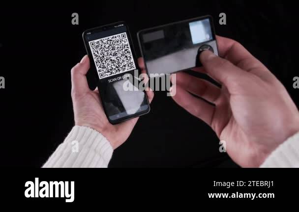 Young man uses portable cold crypto wallet to scan QR code on a ...