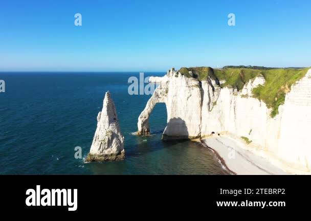 The famous chalk cliffs of Etretat and its long pebble beach, in Europe ...