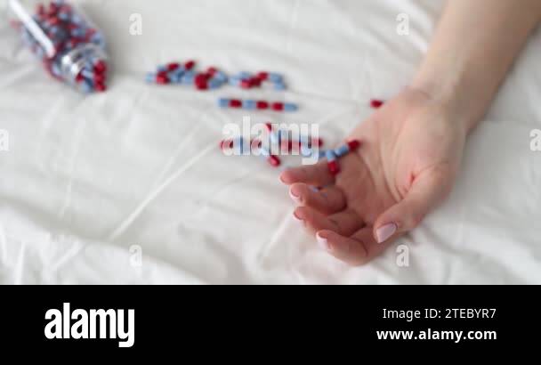 Dead woman lying on bed with scattered medical capsules closeup 4k ...