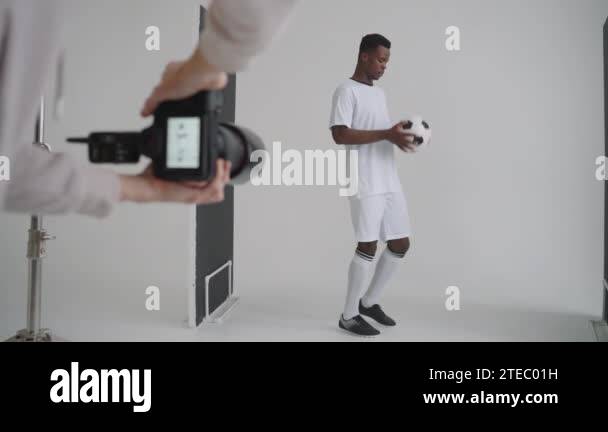 Behind-the-scenes photo shoot: A photographer in a photo studio uses a ...