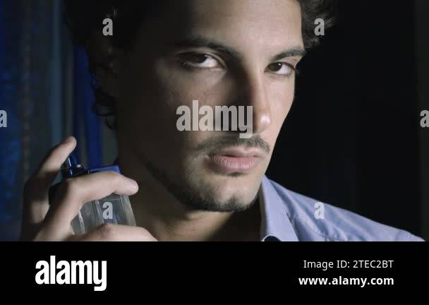 young man spraying perfume Stock Video Footage - Alamy