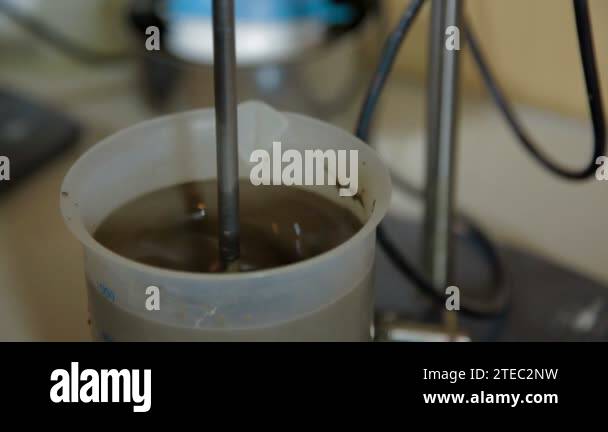 Measuring density of drilling mud in laboratory Stock Video Footage - Alamy