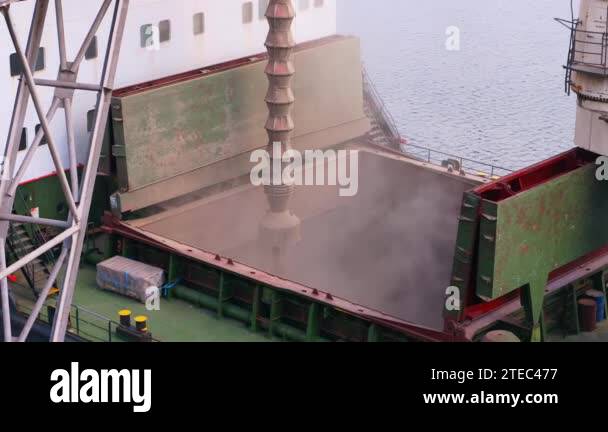 Wheat loading to bulker ship cargo container at sea grain terminal in ...