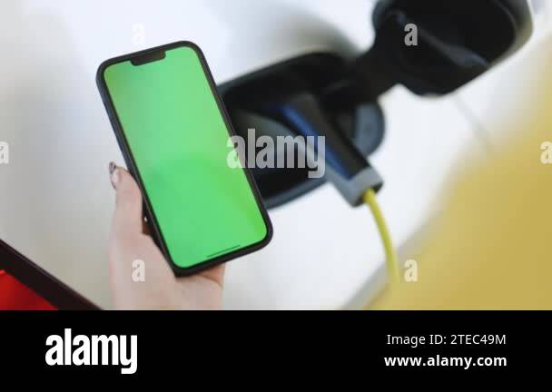 Close up green screen mock up chroma key on mobile phone. EV charging ...