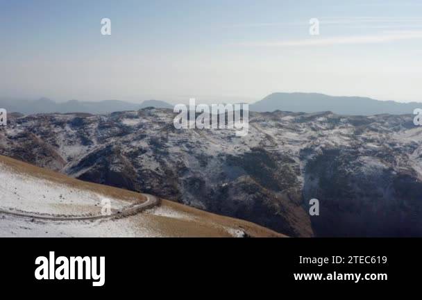 Drone video of a mountain landscape in early winter. Mountain ranges and peaks are sprinkled ...