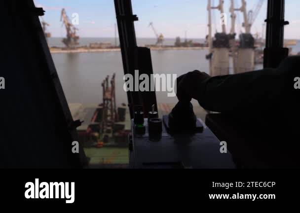 Man hands control joysticks at grain terminal operator cabin workplace ...