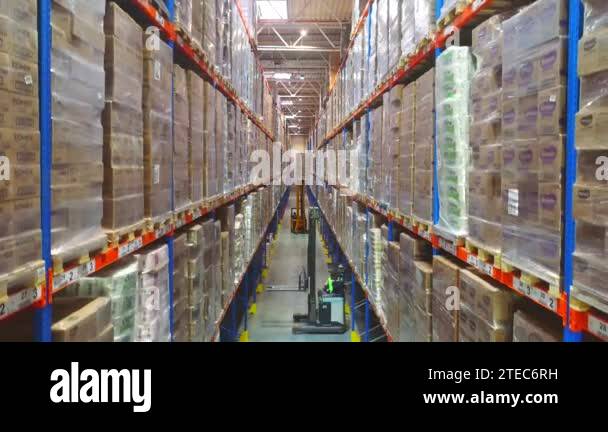 Workflow in a modern warehouse. Modern forklift in a warehouse. Large ...