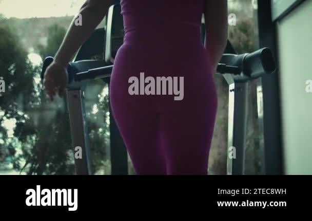 Fit woman training buttocks on sport simulator. Pretty sportive girl ...